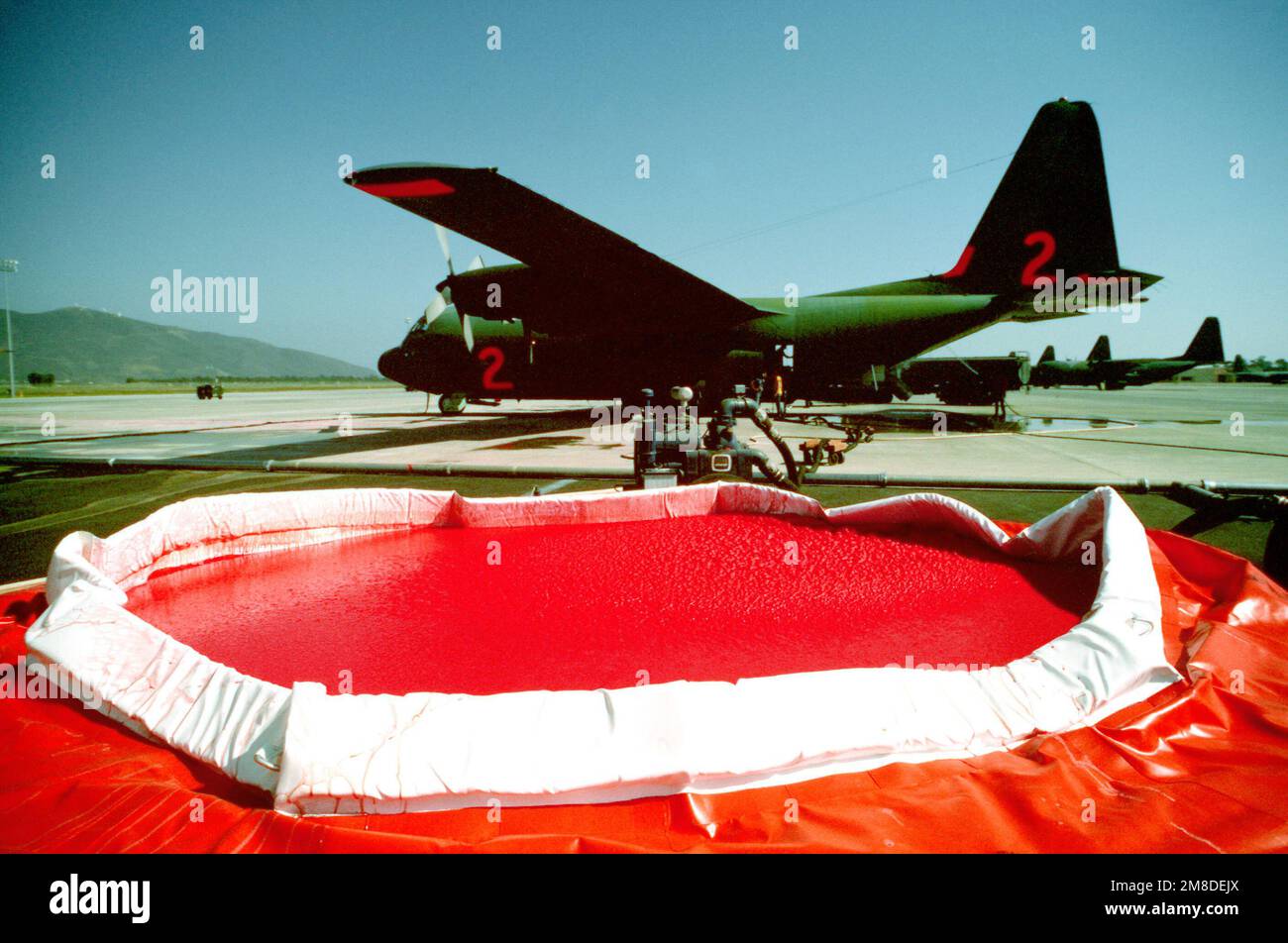 The fire retardant chemical Phos-Chek is pumped into a C-130 Hercules ...