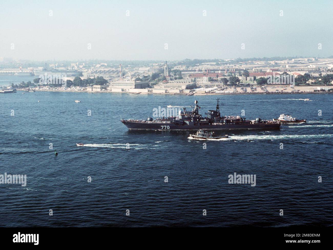 Large harbor tugs escort the Soviet destroyer Boyevoy as the ship ...