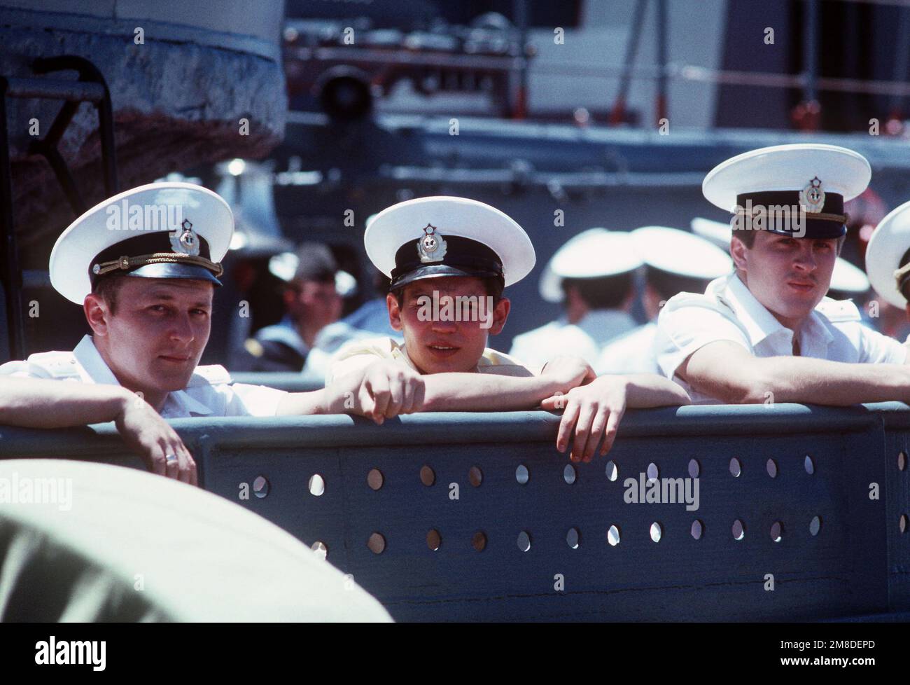 Soviet officers watch passersby from their shipboard vantage point upon ...