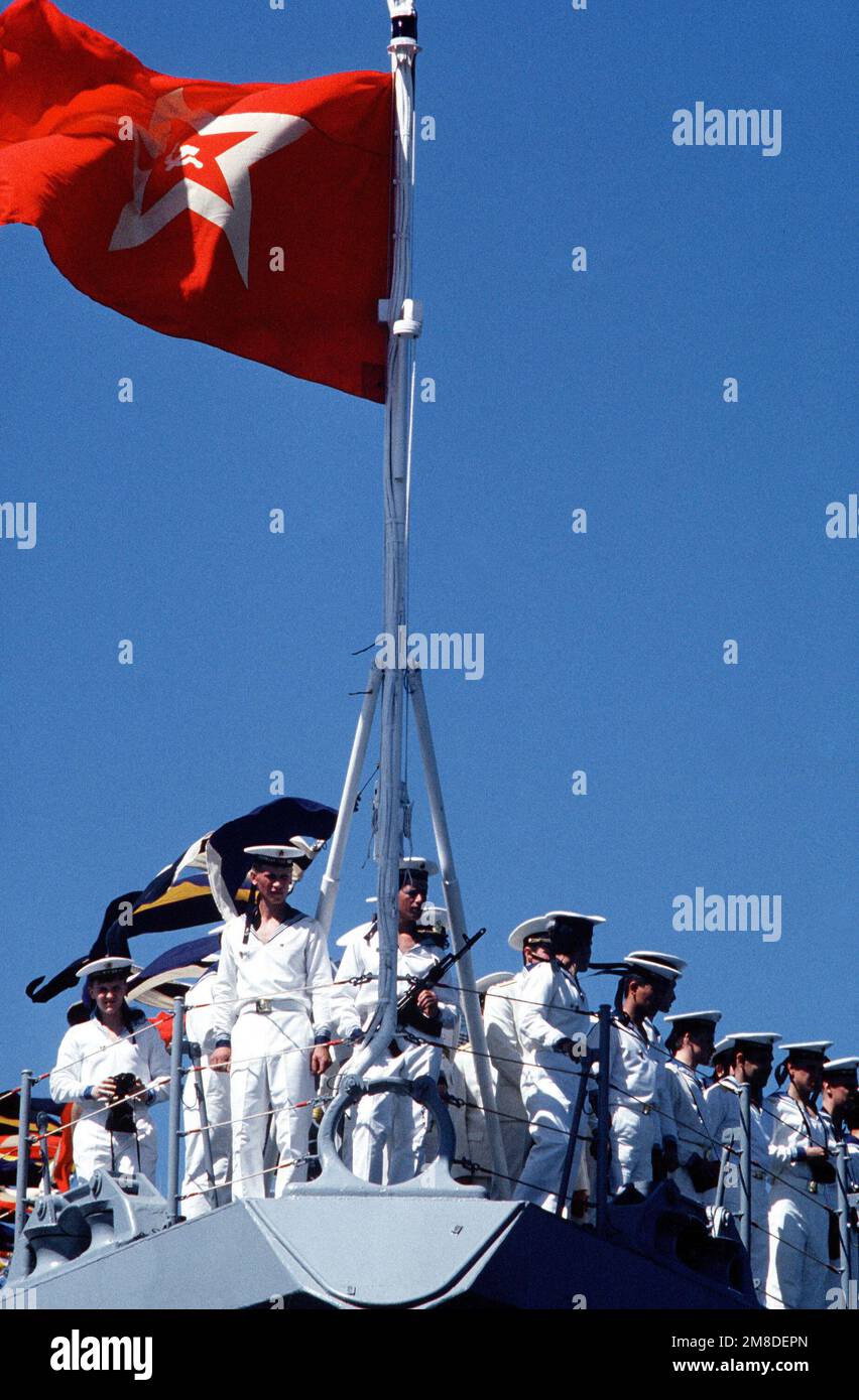 Crew members man the rails on the bow of one of the three ships of the ...