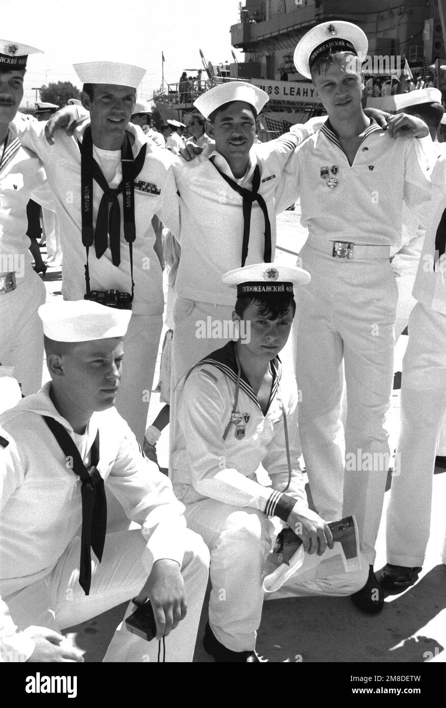 U.S. and Soviet sailors gather in front of the guided missile cruiser ...
