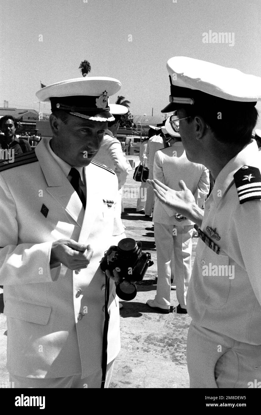 A Soviet captain third rank and a U.S. Navy lieutenant commander talk ...