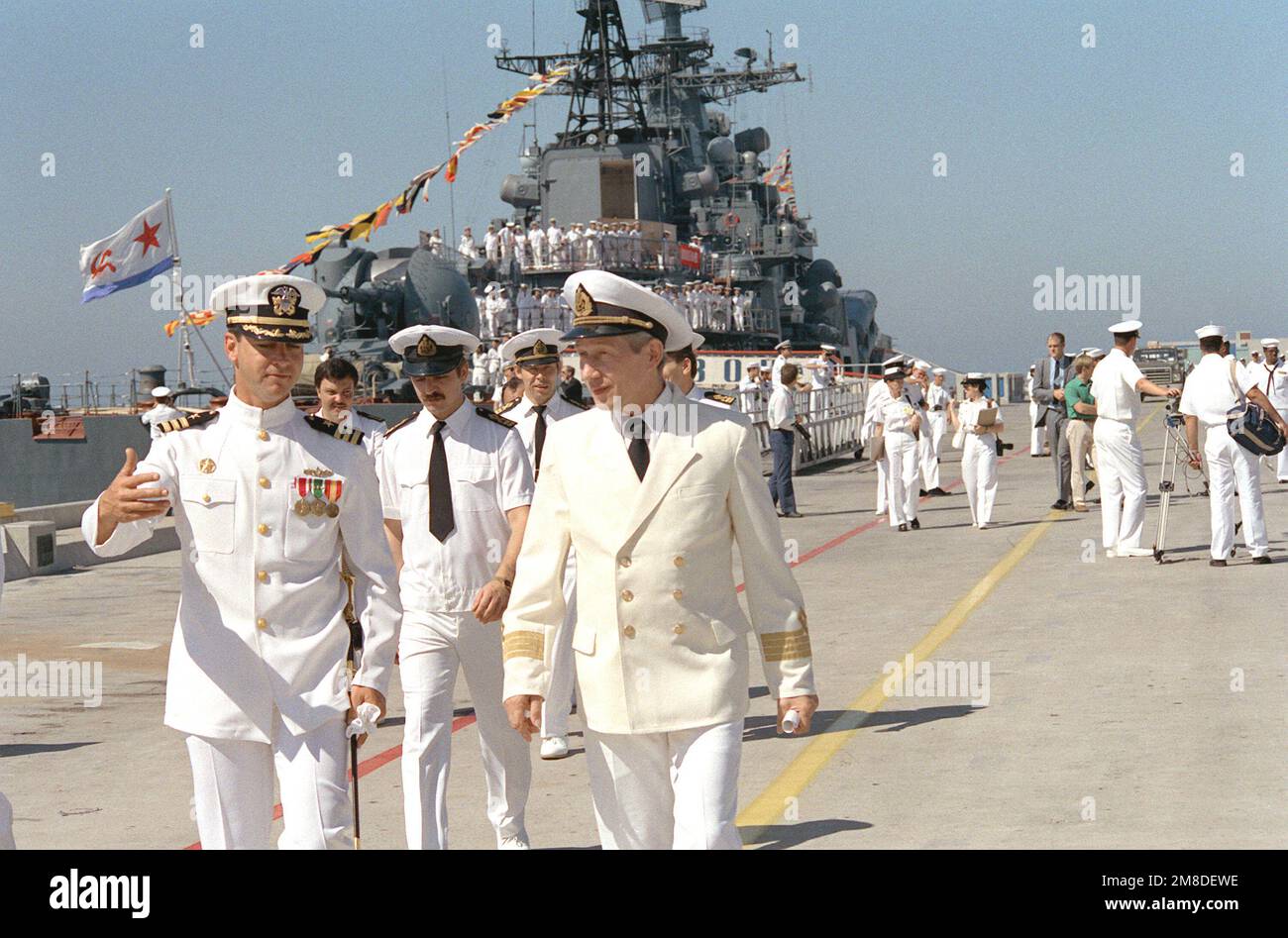 A U.S. Navy commander talks with a Soviet navy captain second rank as ...