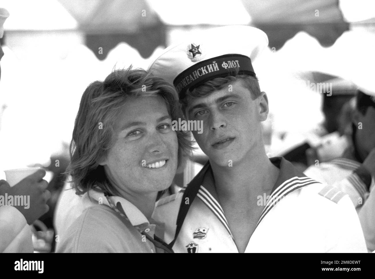 Kathi Weiss, a civilian visitor, stands on the pier beside a Soviet ...