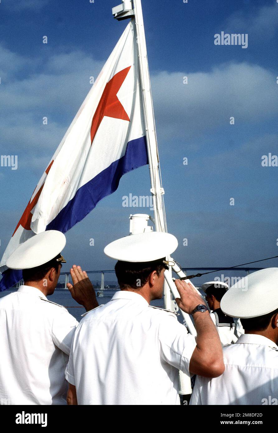 Soviet officers salute as the naval ensign is raised during a colors ...