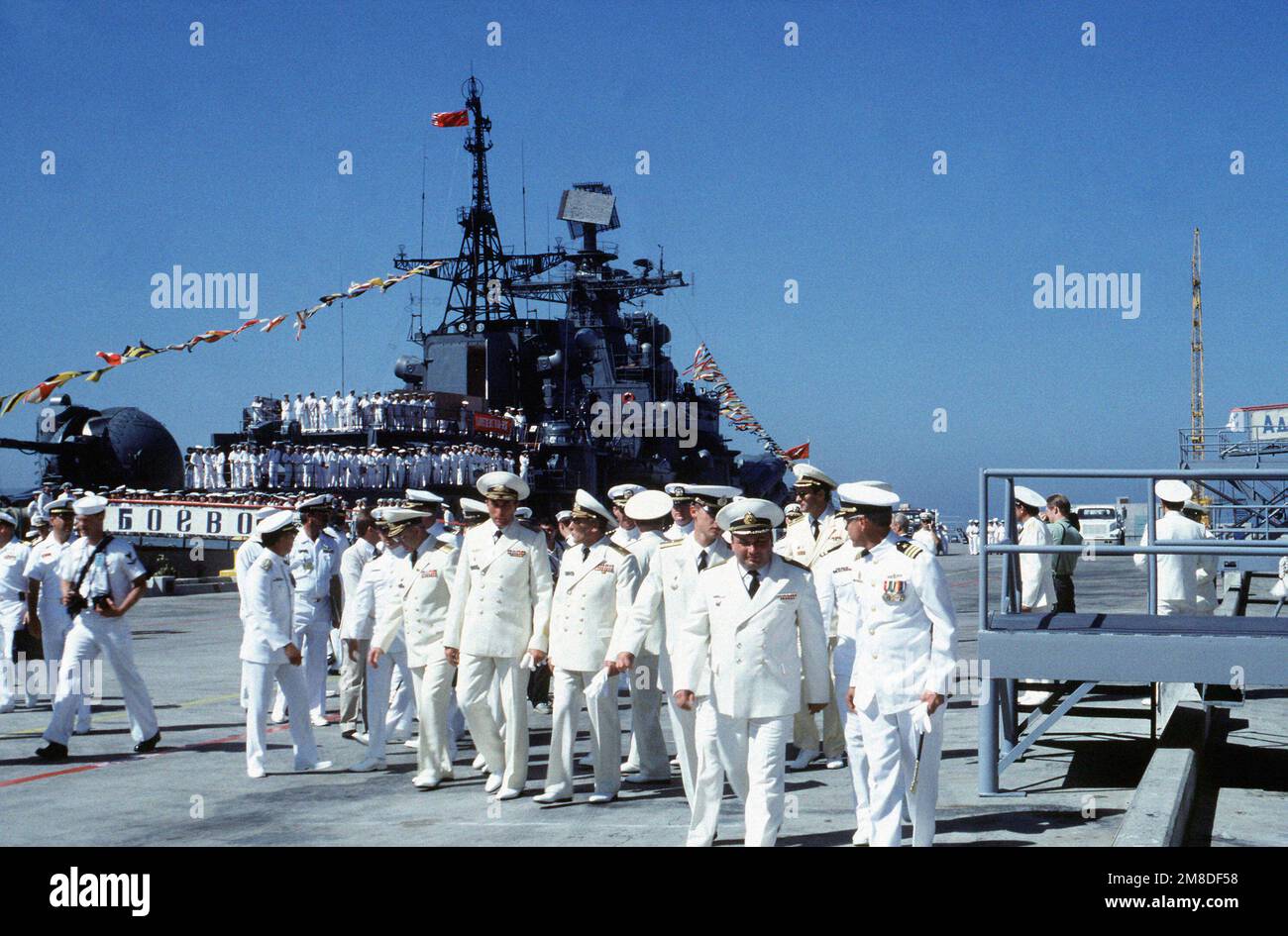 Soviet officers walk along the pier following their arrival at naval ...