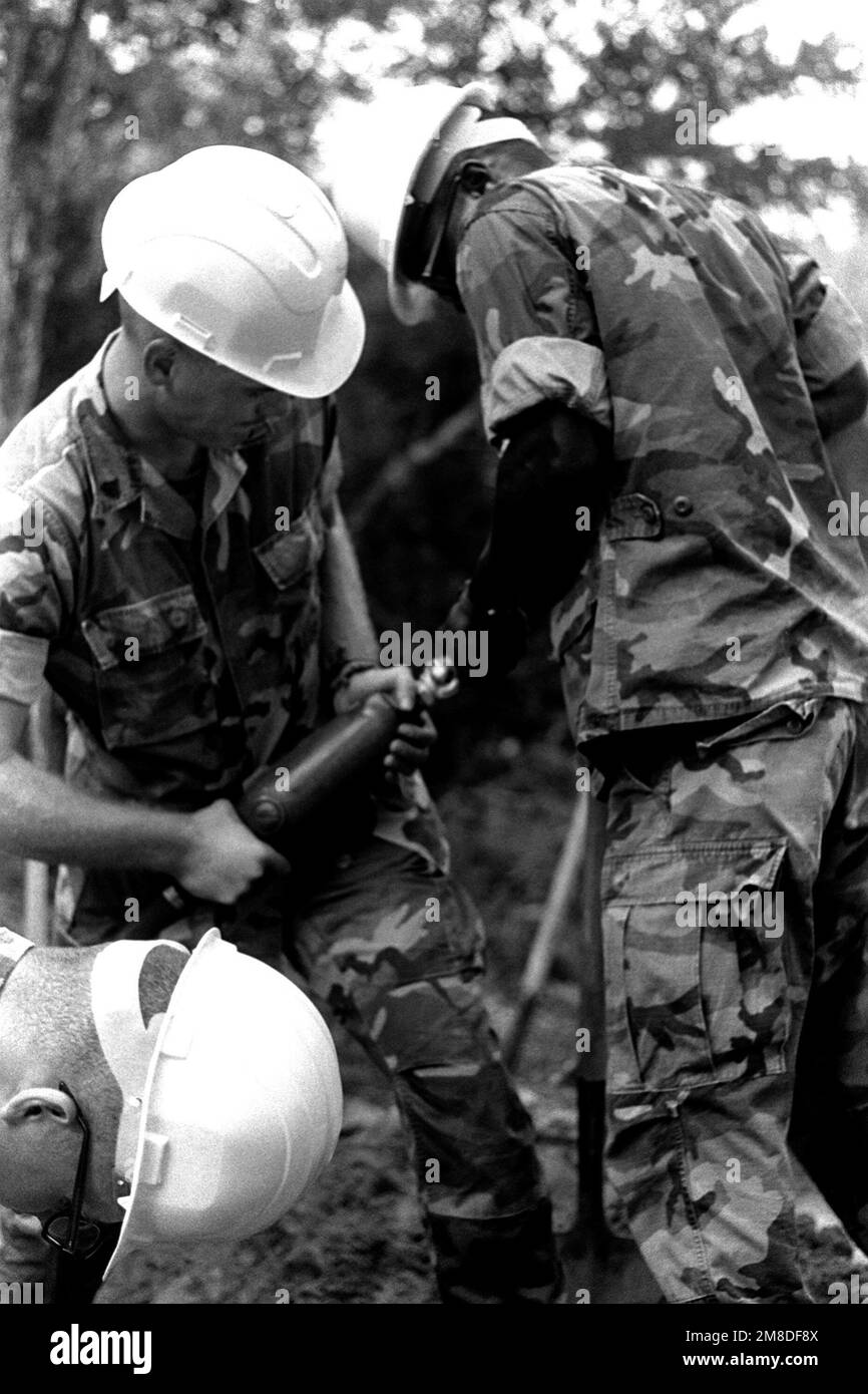 Marine engineers connect a compressed air line while building a bridge ...