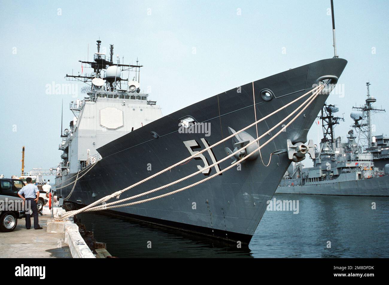The guided missile cruiser USS THOMAS S. GATES (CG-51) lies tied up at ...