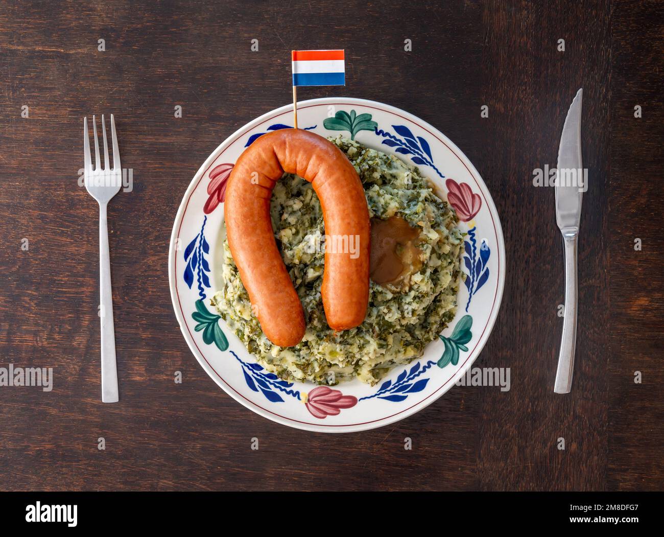 A plate with 'Stamppot Boerenkool met worst' traditional dutch meal ...