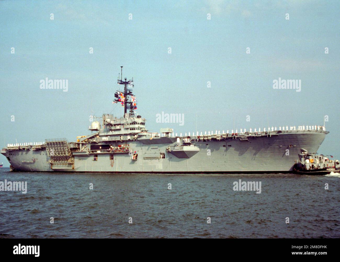 The large harbor tug WATHENA (YTB-825) maneuvers the amphibious assault ...