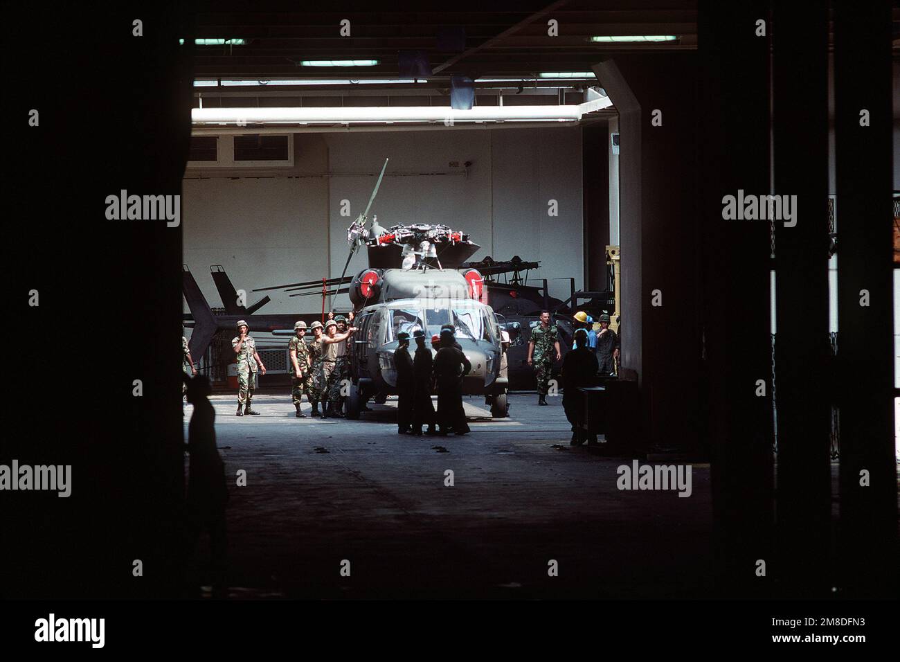 Members of the 24th Infantry Division (Mechanized) stand near a UH-60 ...