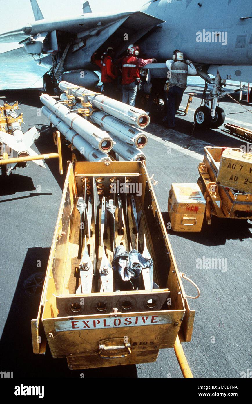 Aviation ordnancemen from Fighter Squadron 142 (VF-142) arm one of ...