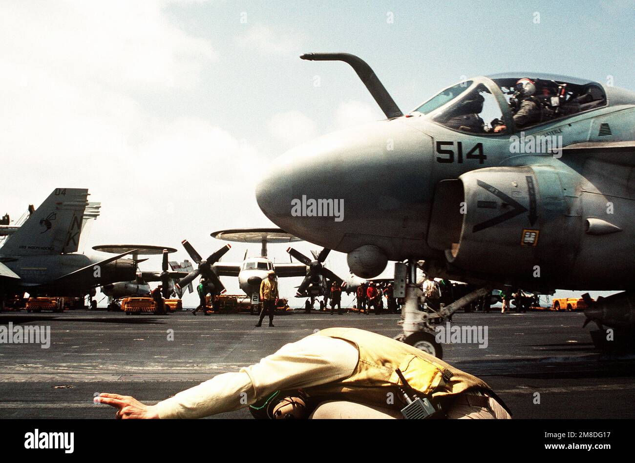 A catapult officer signals for the launch of an Attack Squadron 196 (VA ...