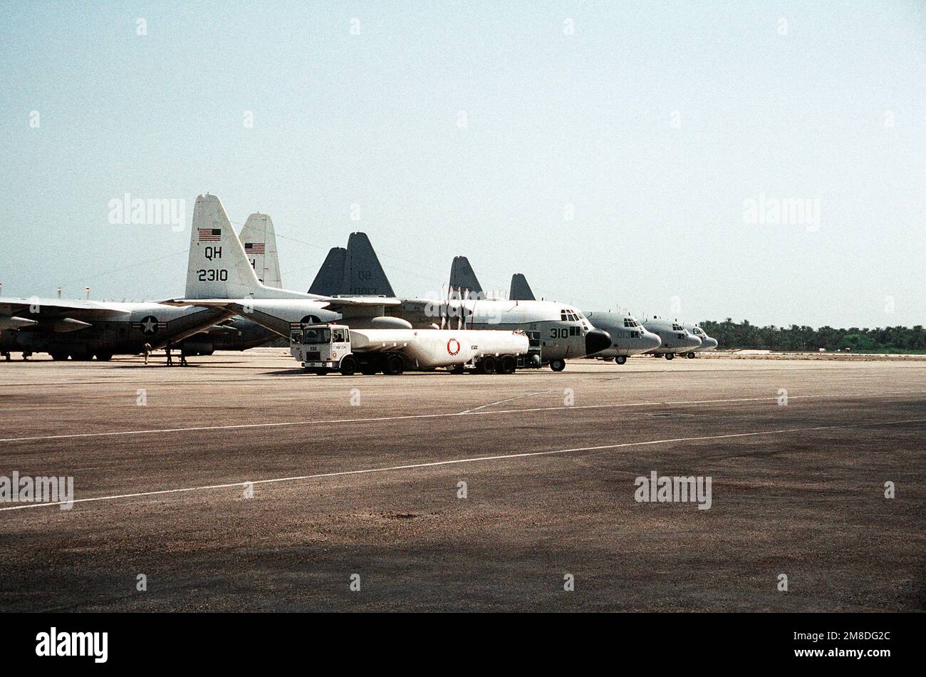 While parked on the flight line beside three KC-130 Hercules aircraft ...