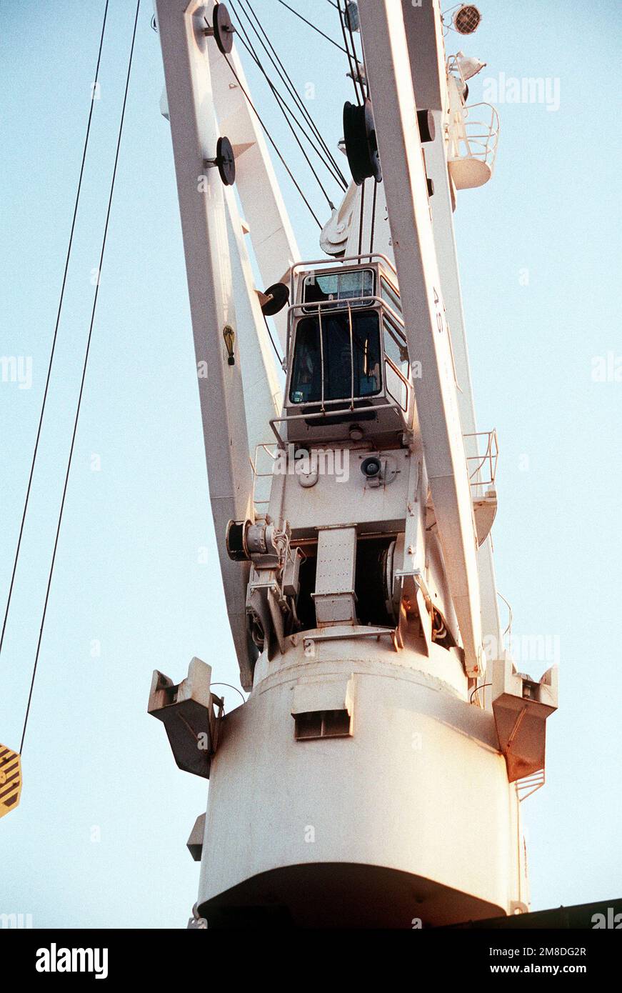 A crew member operates one of the cranes aboard the maritime pre ...