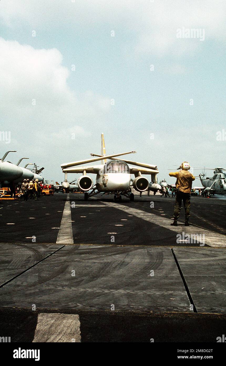 A plane director guides an Air Anti-submarine Squadron 37 (VS-37) S-3A ...
