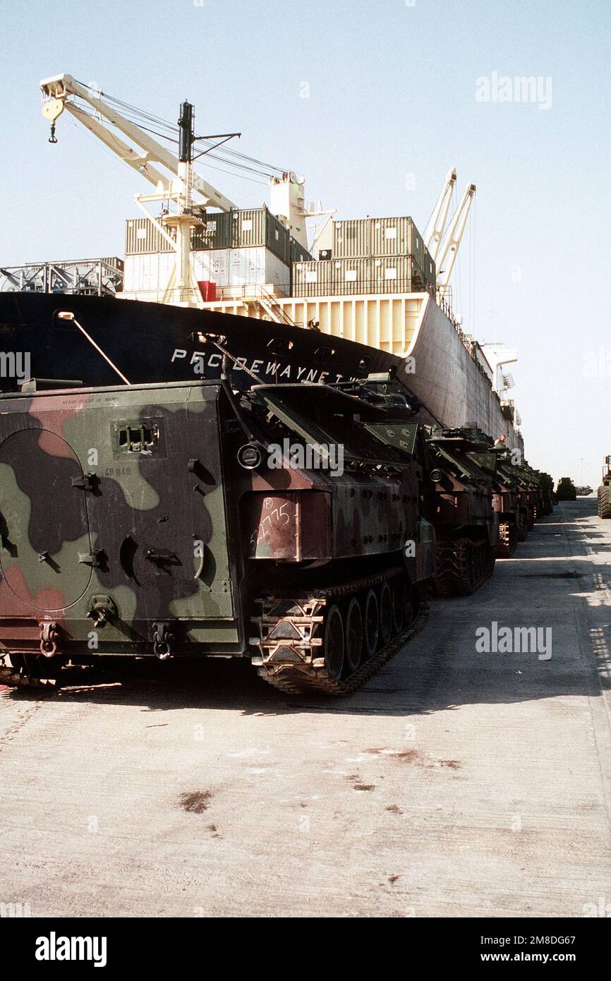 Marine AAVP-7A1 amphibious assault vehicles line the pier beside the ...