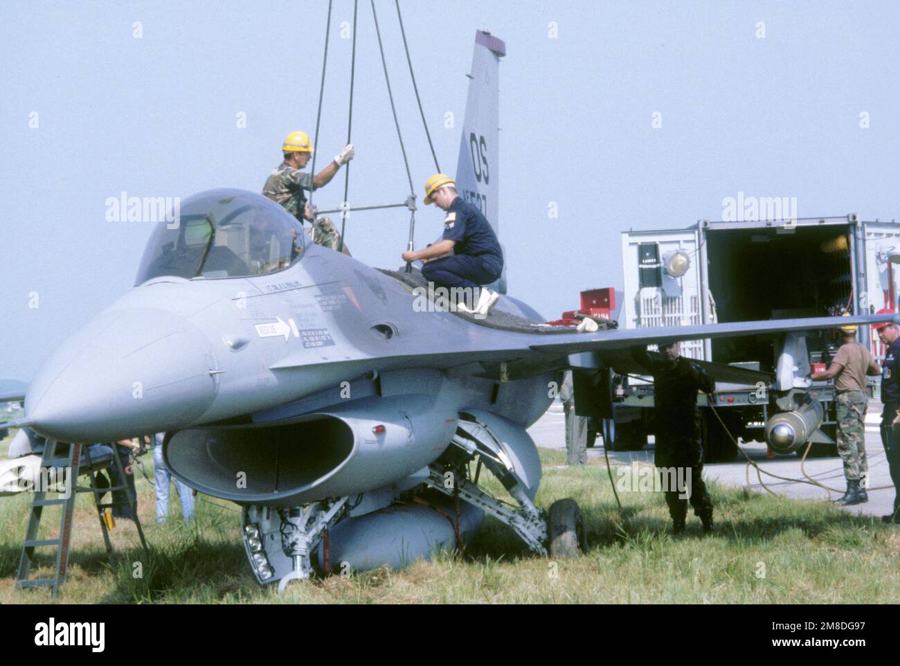 Members of the 51st Tactical Fighter Wing crash recovery crew attach ...