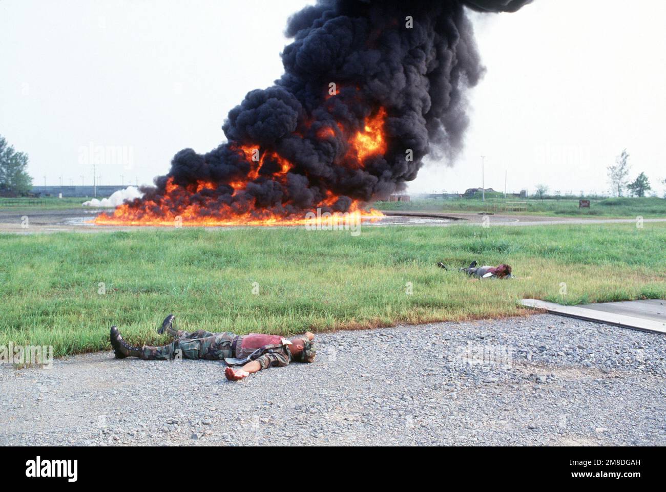 Simulated casualties lie around the edges of a fire during an accident ...