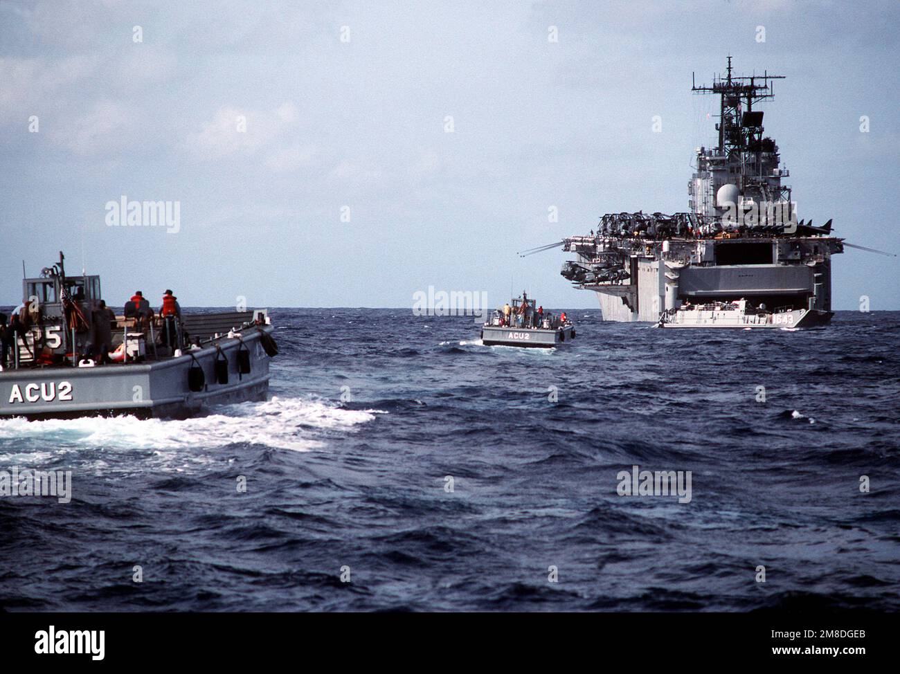 Two LCM-8 mechanized landing craft approach the amphibious assault ship ...