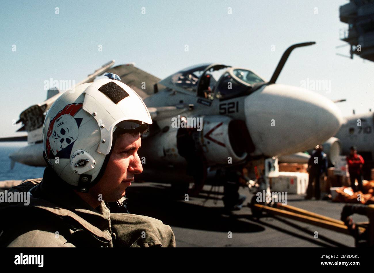 An Attack Squadron 34 (VA-34) air crewman walks past one of his ...
