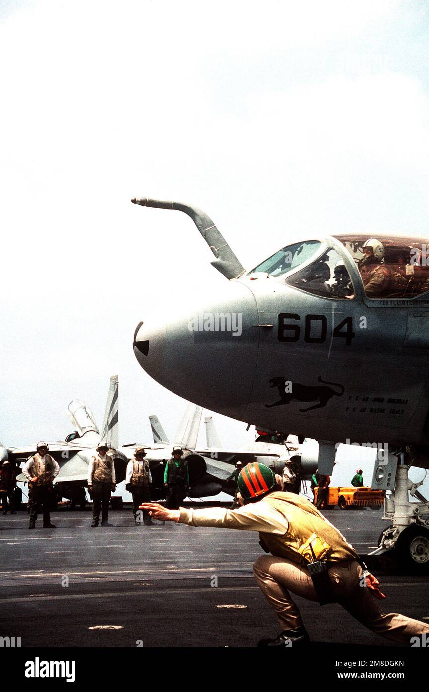 A catapult officer gives the signal to launch a Tactical Electronic ...