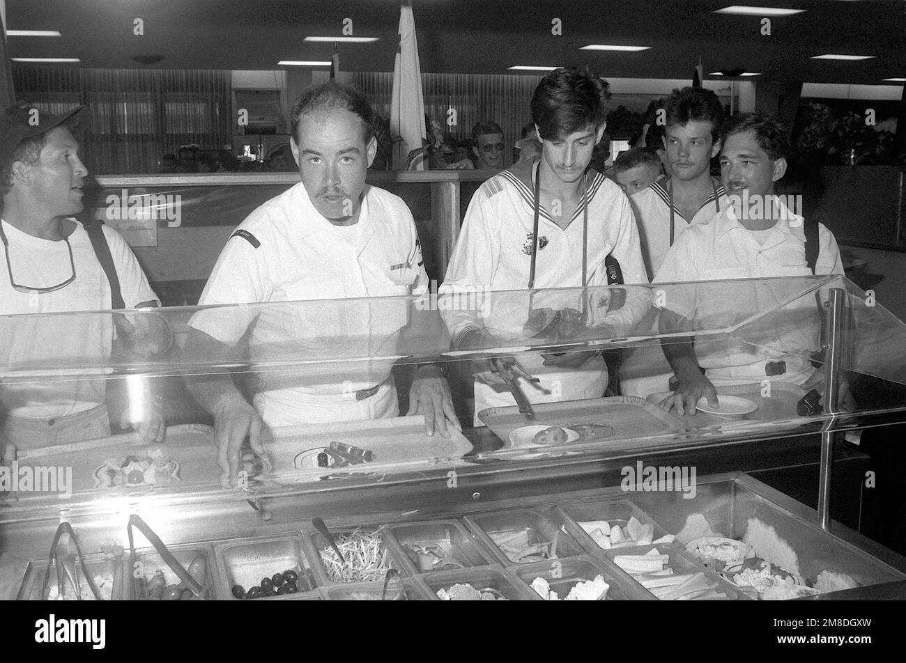 American and Soviet sailors make their way through the mess line at the ...