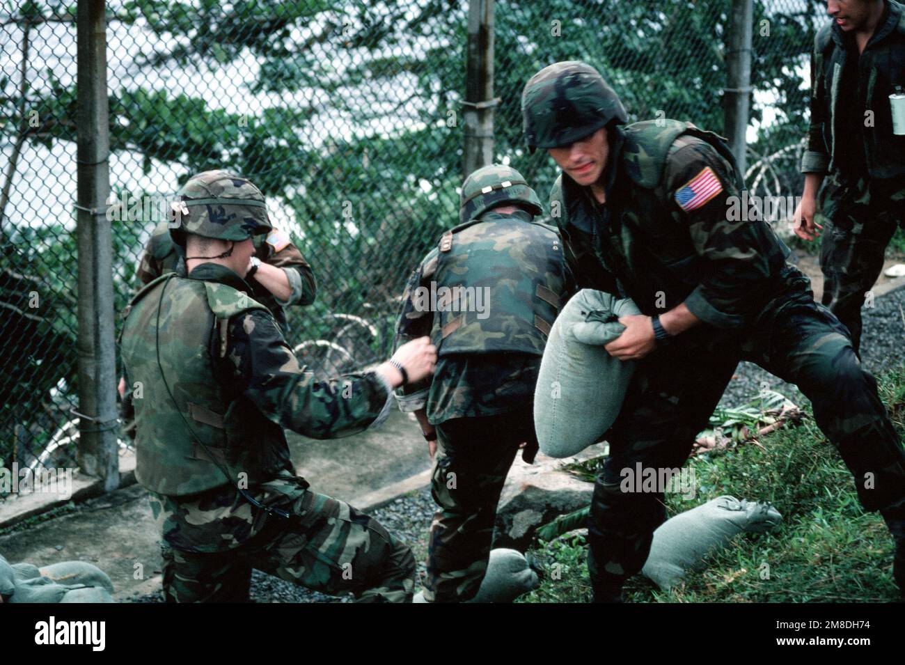 Marines on the grounds of the US Embassy sandbag a position near the ...