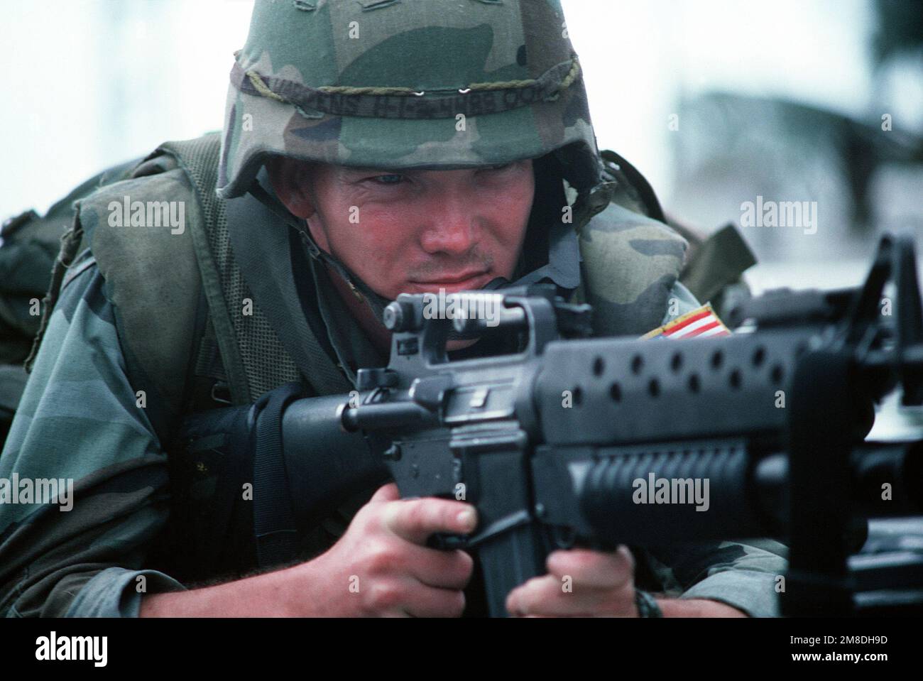 A Marine armed with an M16A2 rifle equipped with an M203 grenade ...