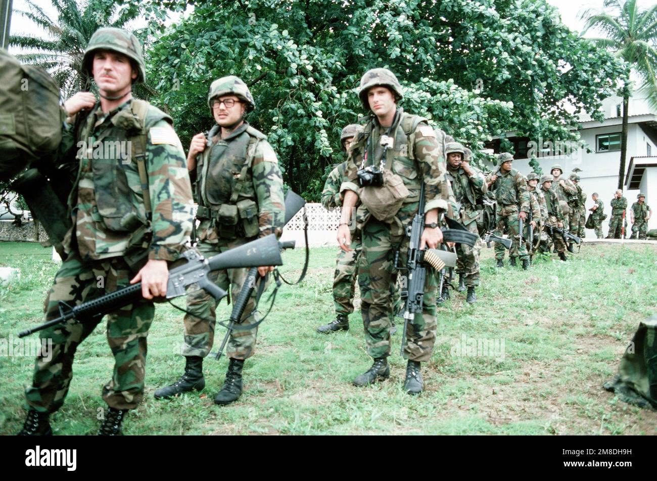 Marines on the grounds of the US Embassy wait in line to board a ...