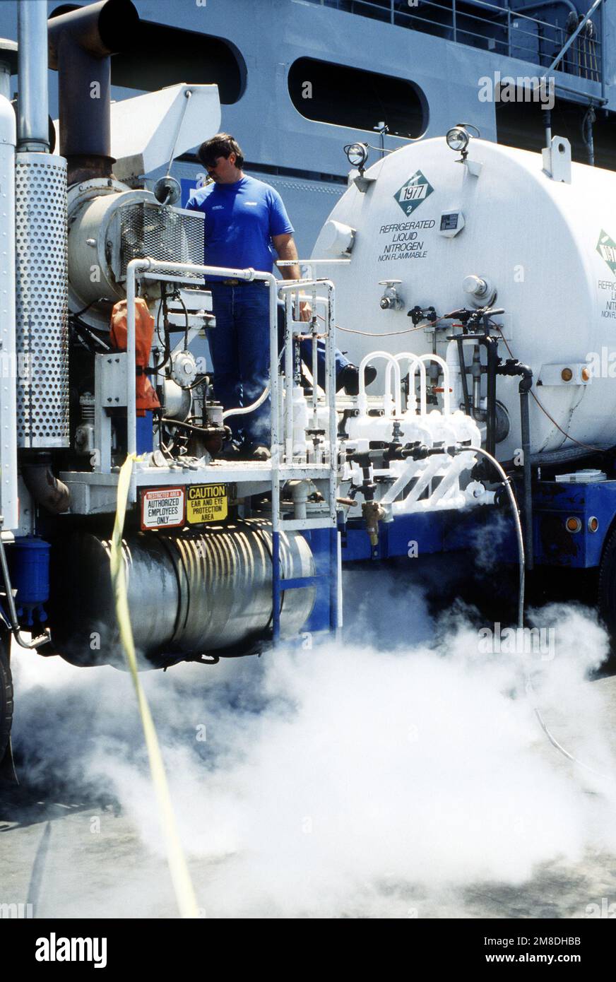 A worker operates the controls of a delivery truck as the nuclear ...