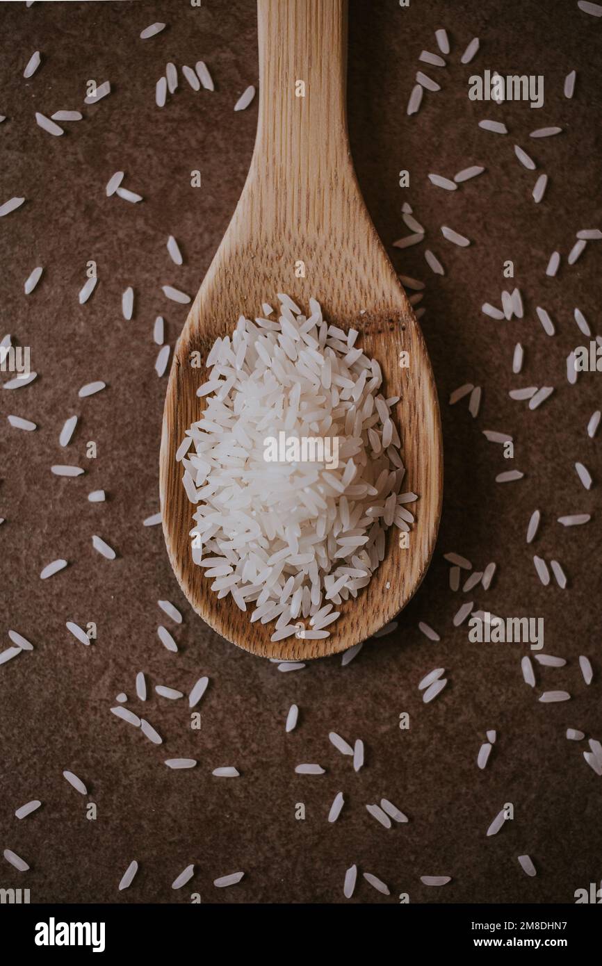 Rice and wooden spoon Stock Photo - Alamy
