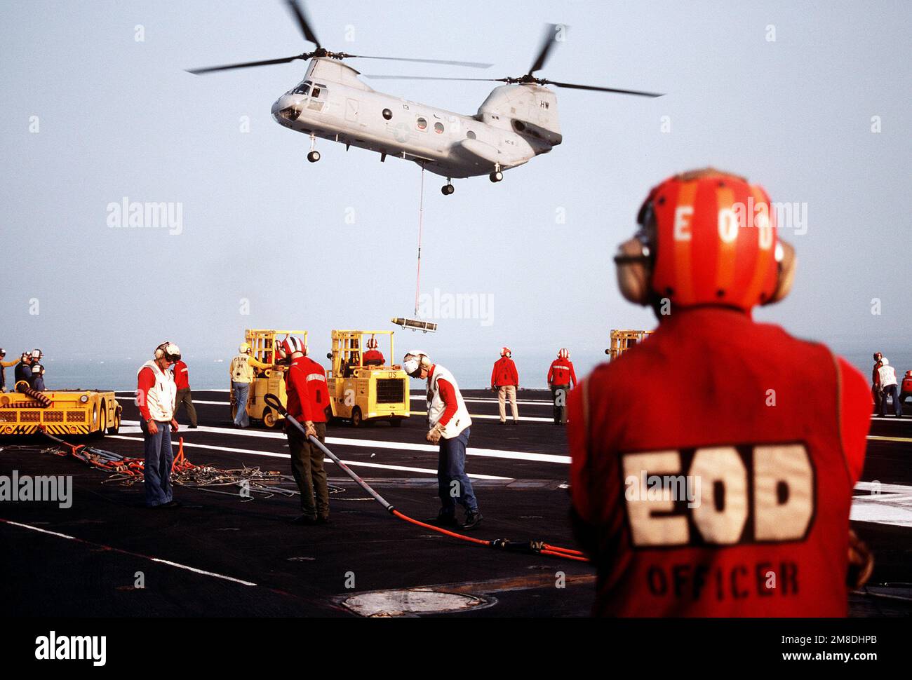 Ordnance crew members stand by as a Helicopter Combat Support Squadron ...