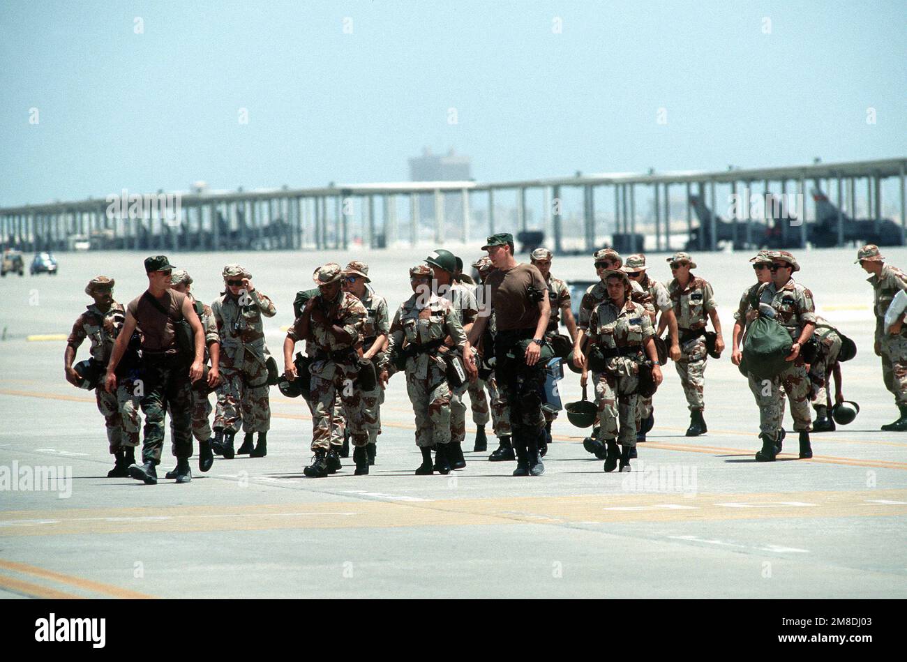 Newly arrived personnel are led across the flight line to a terminal ...