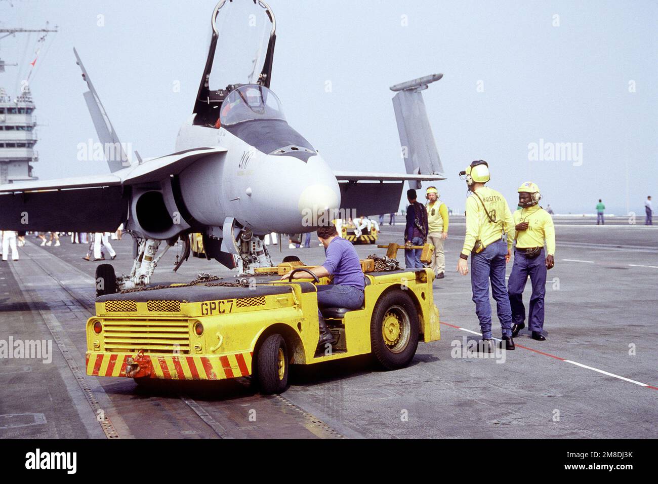 A flight deck crewman aboard the nuclear-powered aircraft carrier USS ...