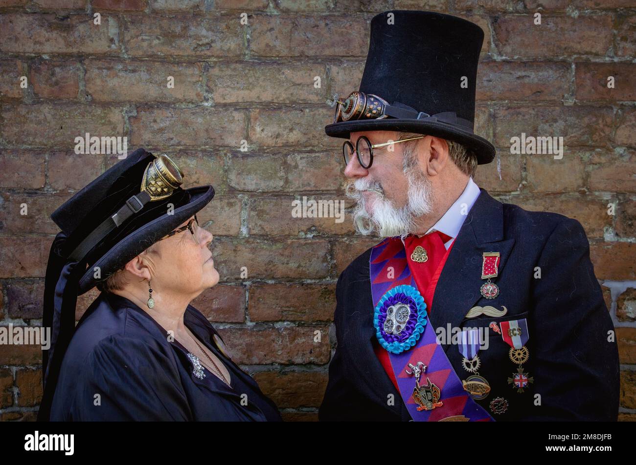 Portrait of a male and female steampunk looking into each others eyes ...