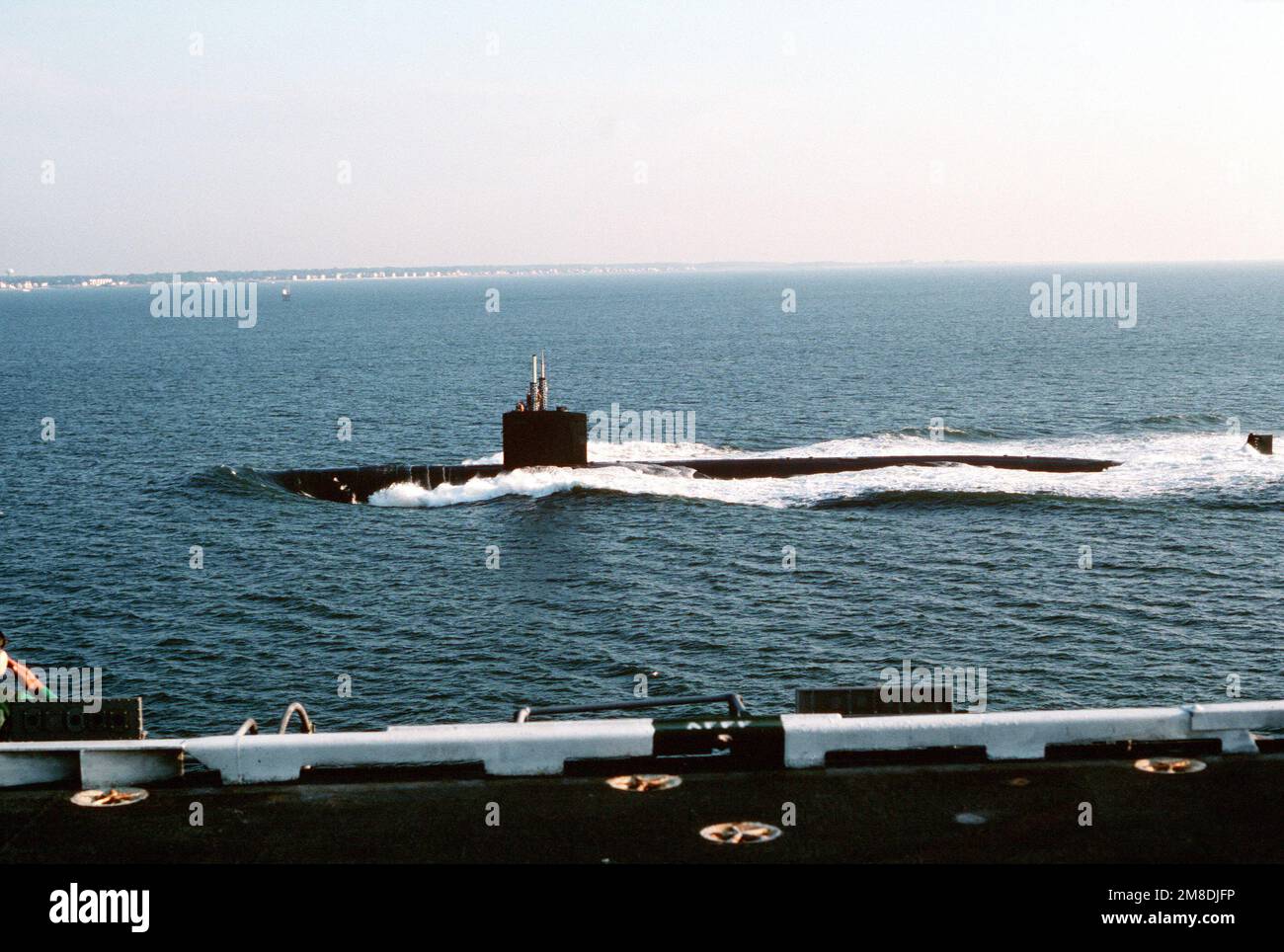 The nuclear-powered attack submarine USS HELENA (SSN-725) and the ...