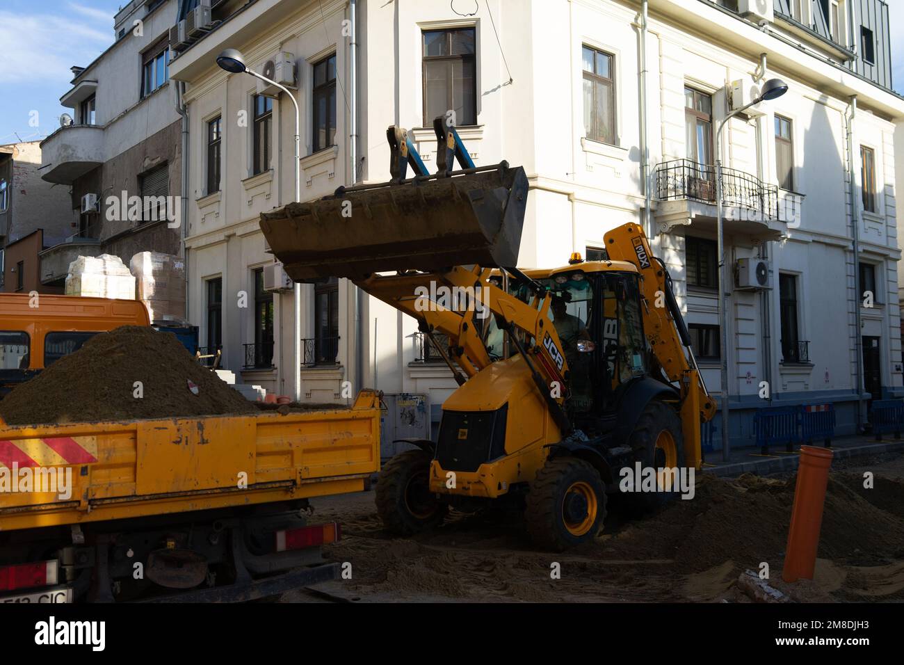 Construction workers at construction site and heavy duty bulldozer in ...