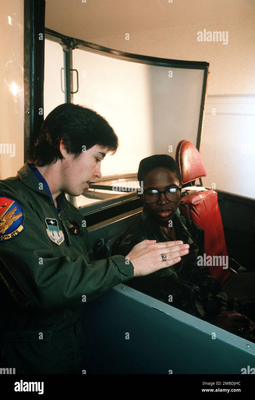 SGT Chris O'Keefe demonstrates a point as she briefs Cadet Alvin ...