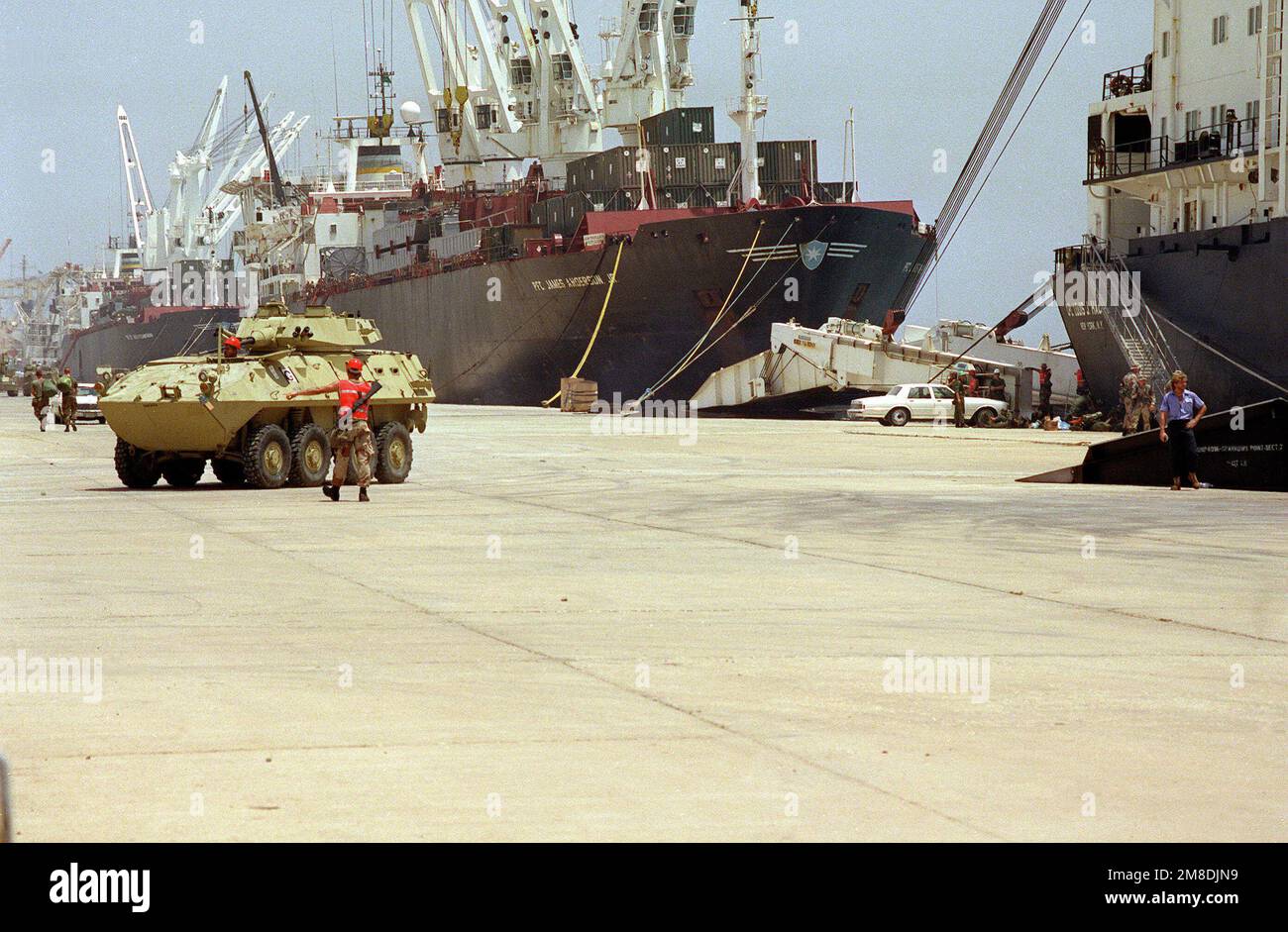 A Marine guides the driver of an LAV-25 light armored vehicle as ...