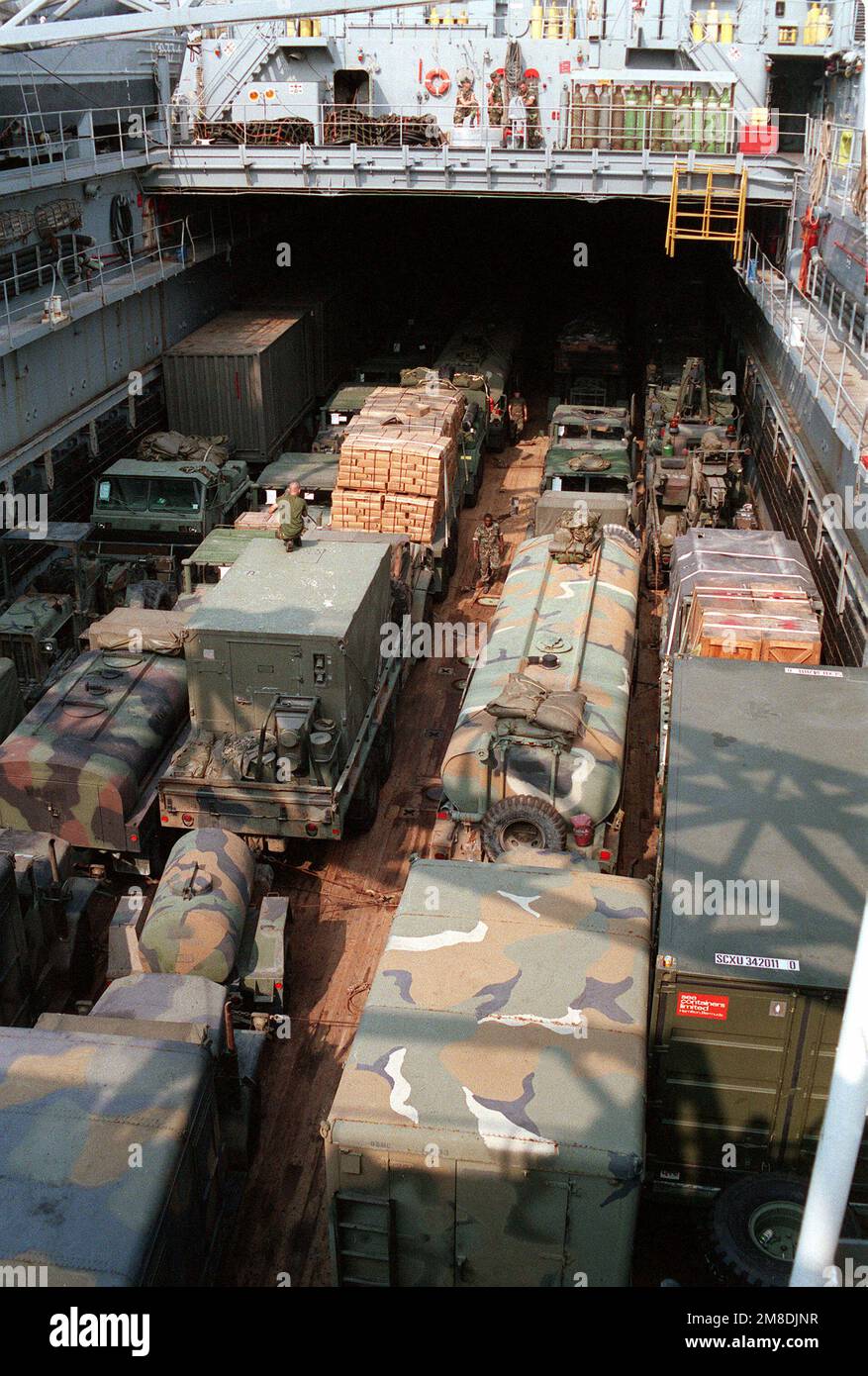 Marines work to secure vehicles in the well deck of the dock landing ...