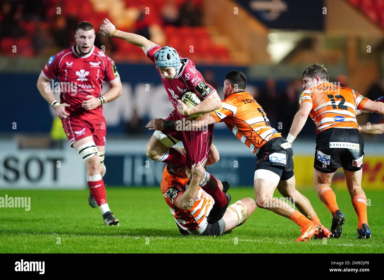 Scarlets' Jonathan Davies is tackled by Toyota Cheetahs' Rynier ...