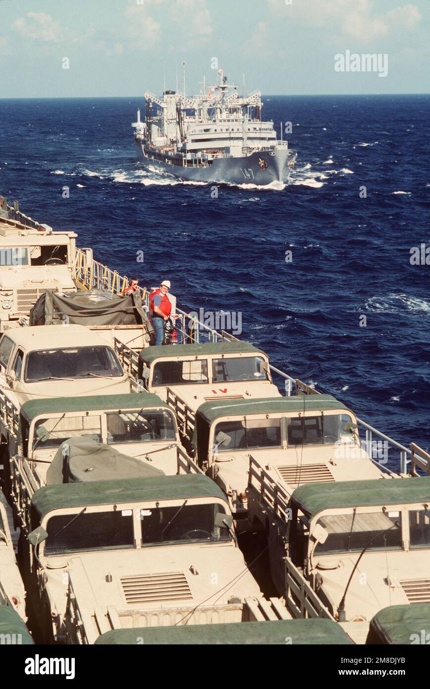 Crew members stand by on the deck of the rapid-response vehicle cargo ...