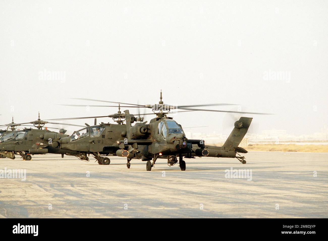 Two AH-64 Apache helicopters depart for a training flight during ...