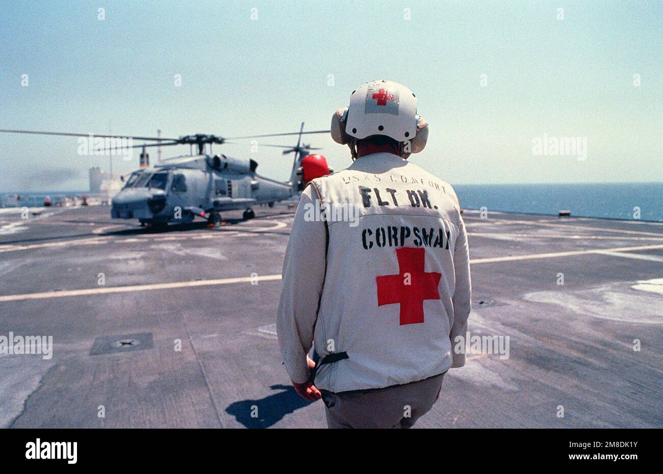 A medical corpsman stands by on the flight deck of the USNS COMFORT (T ...