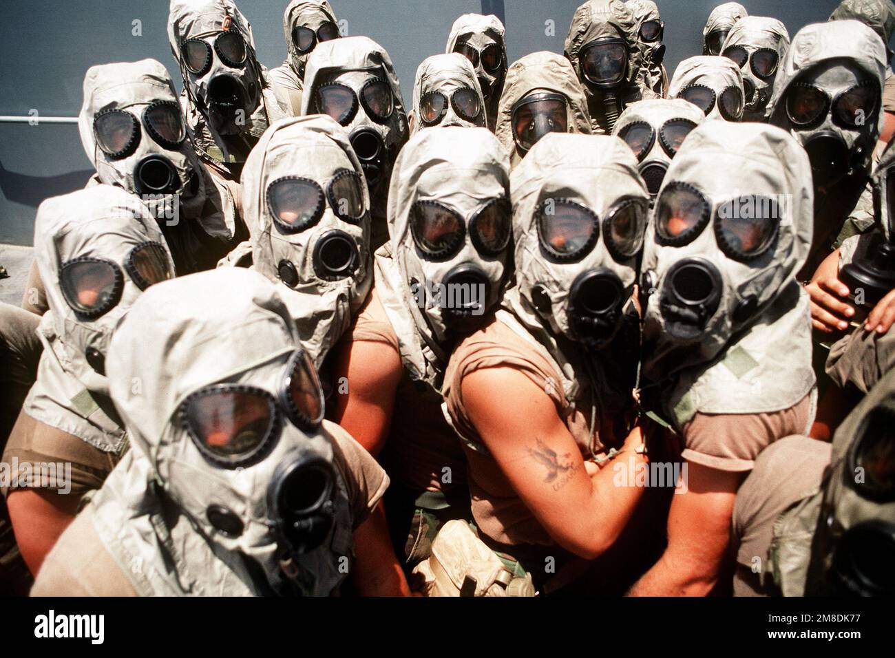 U.S. Army personnel wear M-17A1 gas masks during a drill aboard the ...