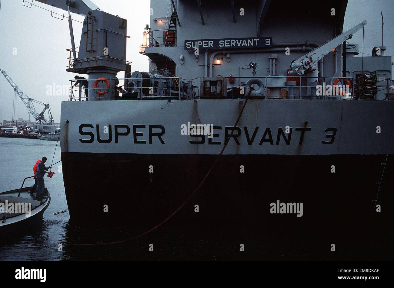 A small boat lies tied up alongside the partially submerged ...