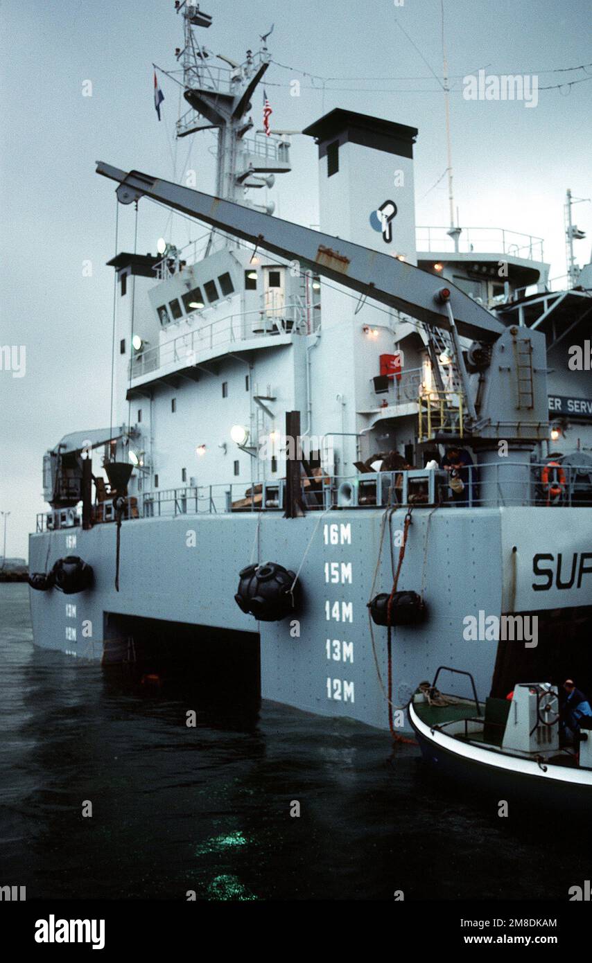 A small boat lies tied up alongside the partially submerged ...