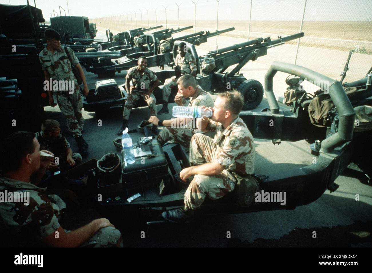 Members of an 82nd Airborne Division artillery battery sit on their M ...