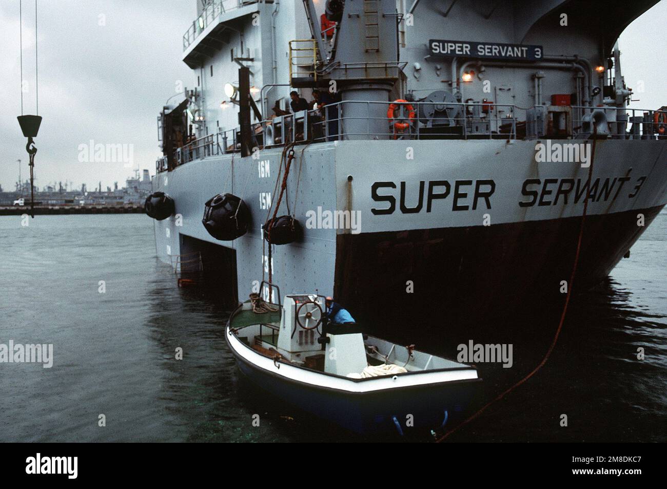 A small boat lies tied up alongside the partially submerged ...